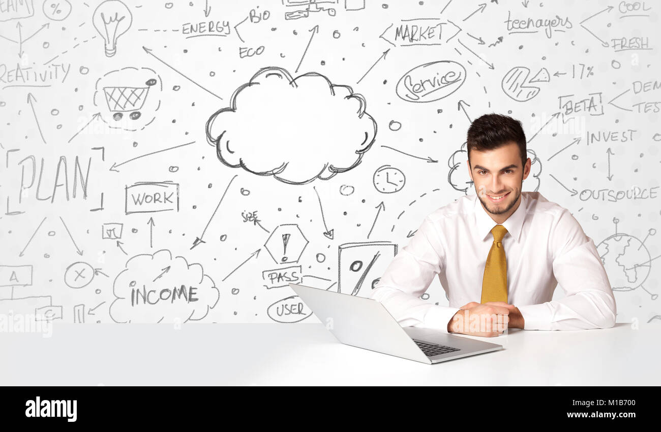 Businessman sitting at white table with hand drawn business concept ...