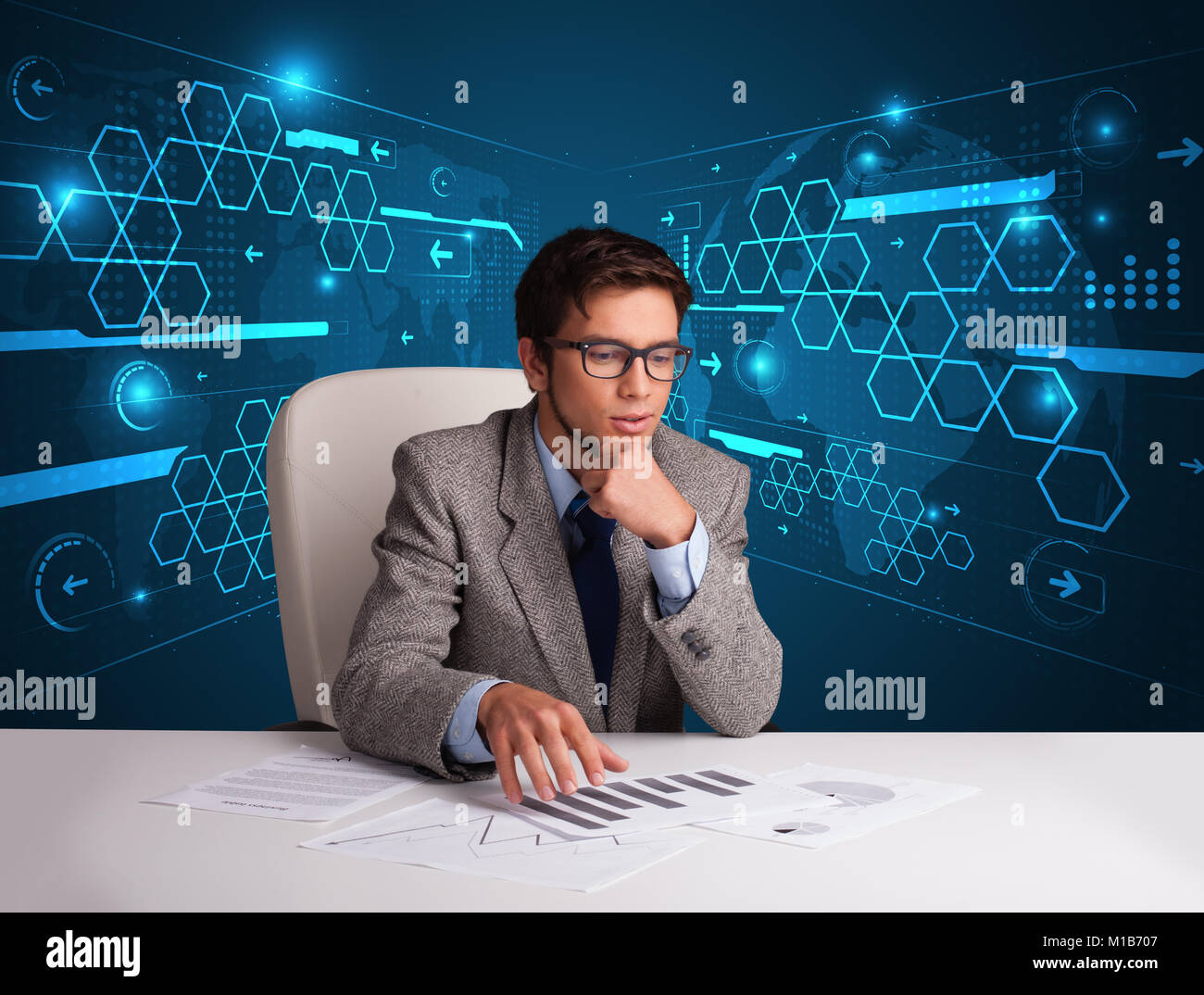 Young businessman doing paperwork with futuristic backgroung Stock ...