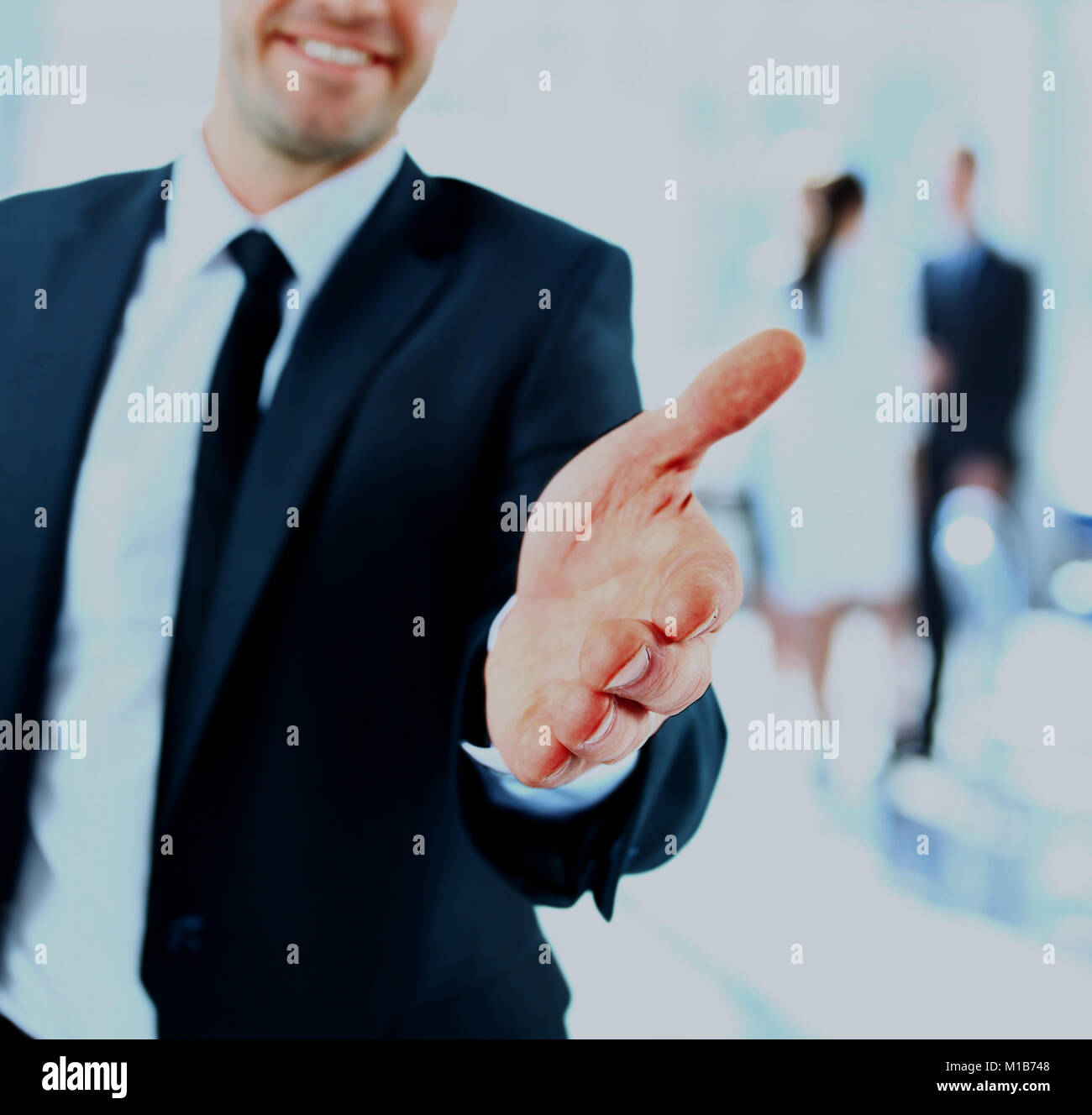 Businessman offering a handshake Stock Photo - Alamy
