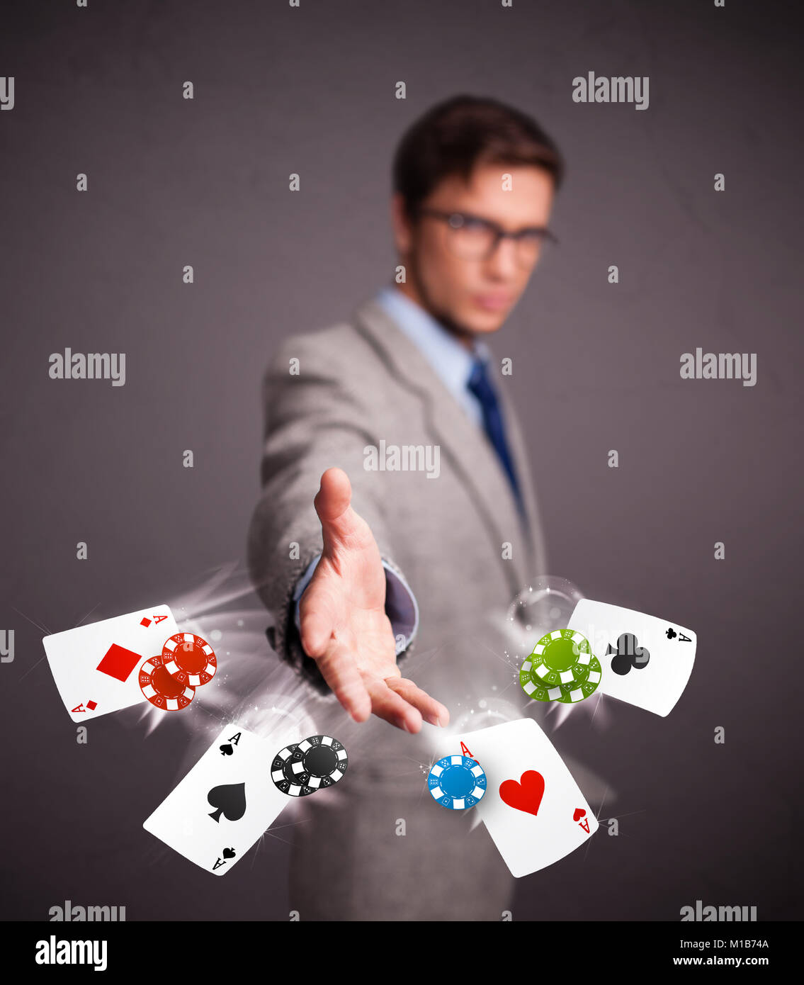 Handsome young man playing with poker cards and chips Stock Photo - Alamy