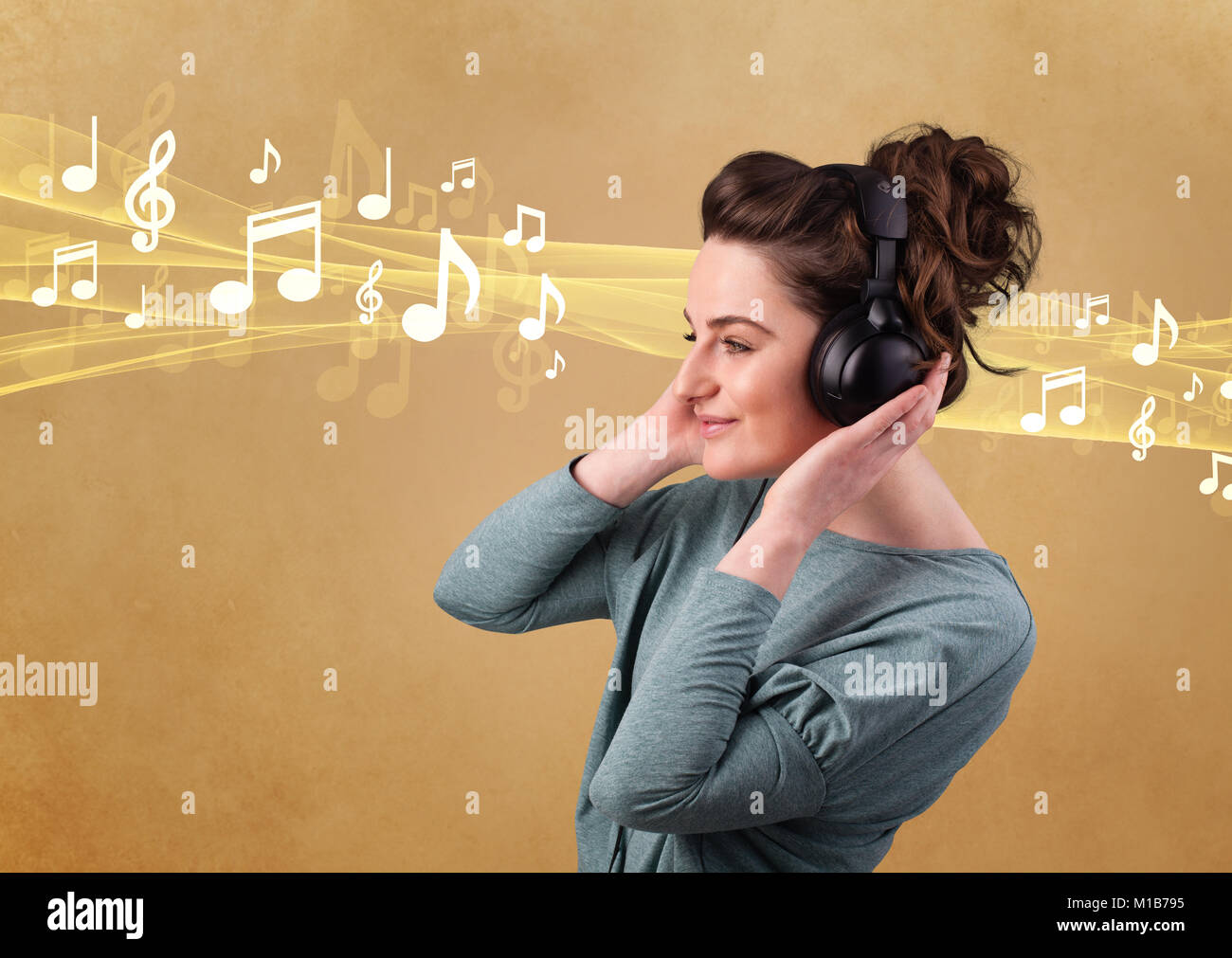Pretty young woman listening to music, notes concept Stock Photo - Alamy