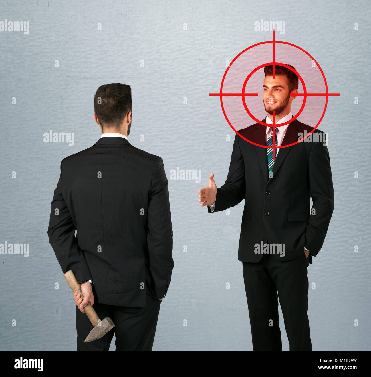 Ruthless businessman handshake with a hiding weapon and a head target ...
