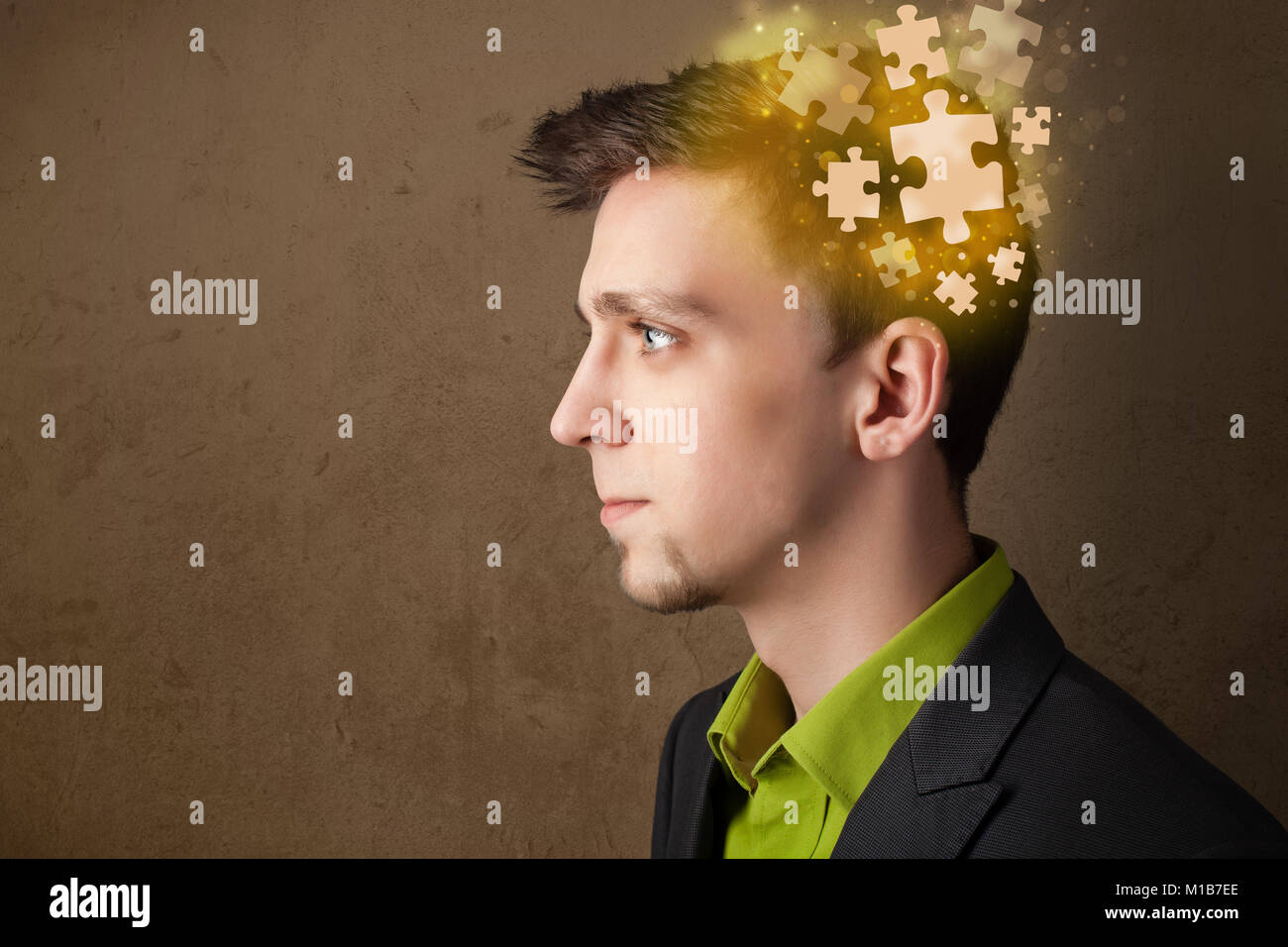 Young person thinking with glowing puzzle mind on grungy background ...