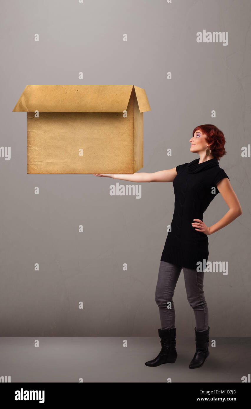 Beautiful young woman holding an empty cardboard box Stock Photo - Alamy