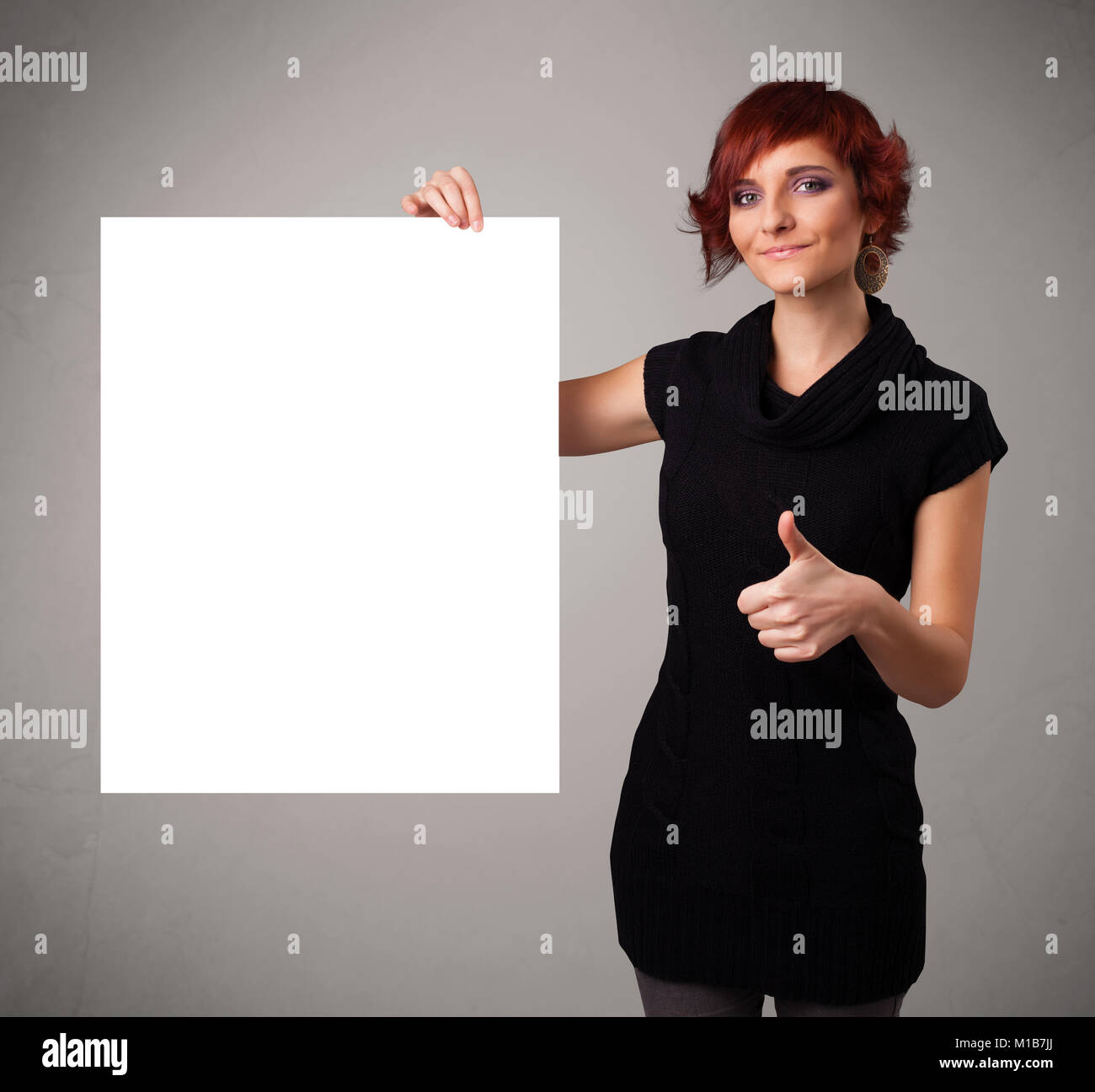 Pretty young woman presenting white paper copy space Stock Photo - Alamy