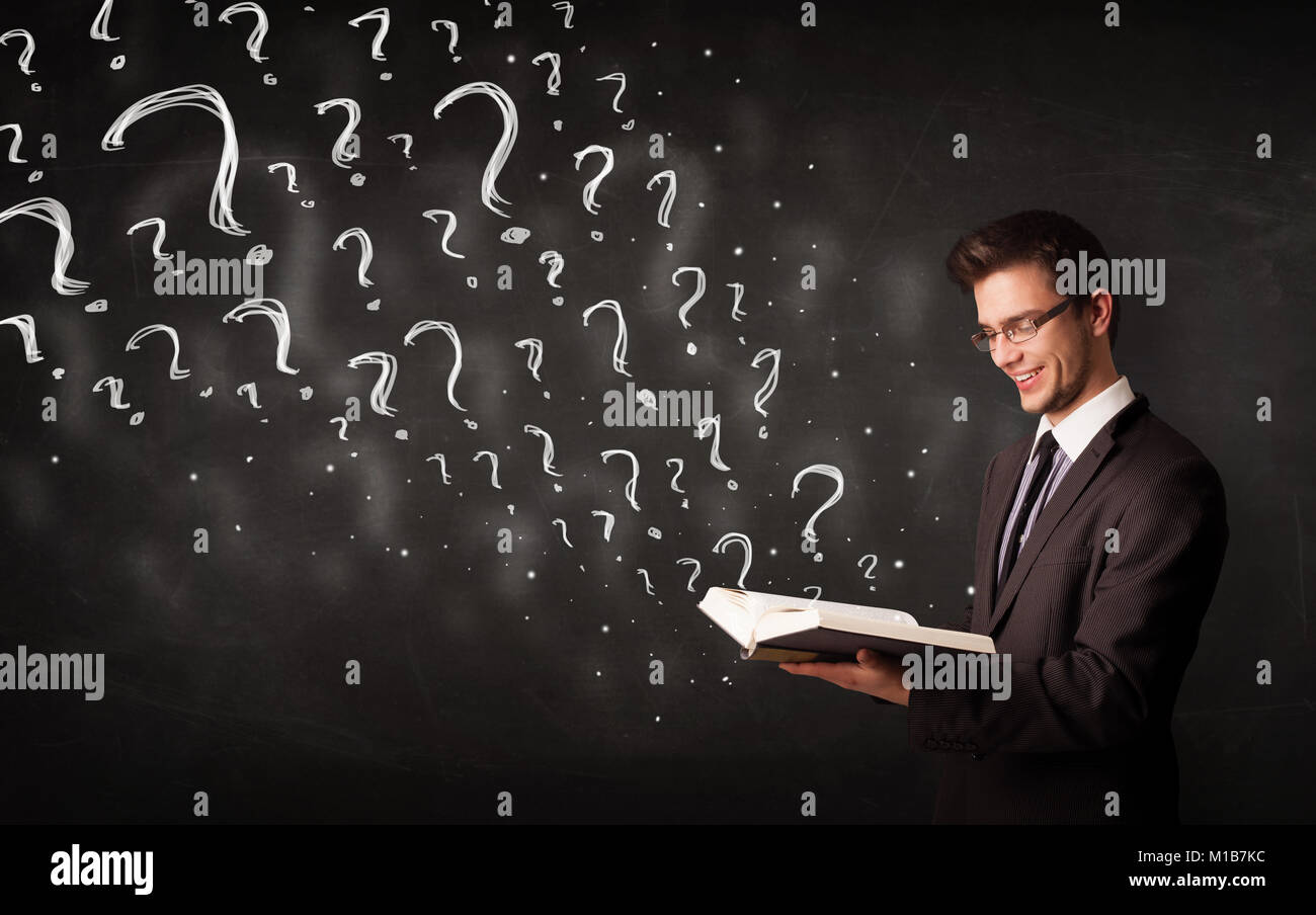 Confused man reading a book with question marks coming out from it ...