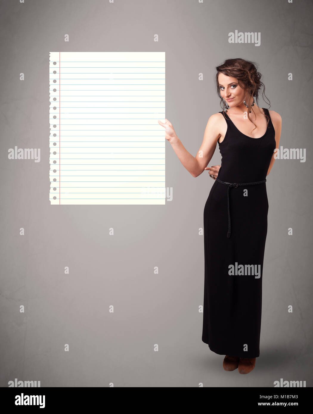 Pretty young lady holding white paper copy space with diagonal lines ...