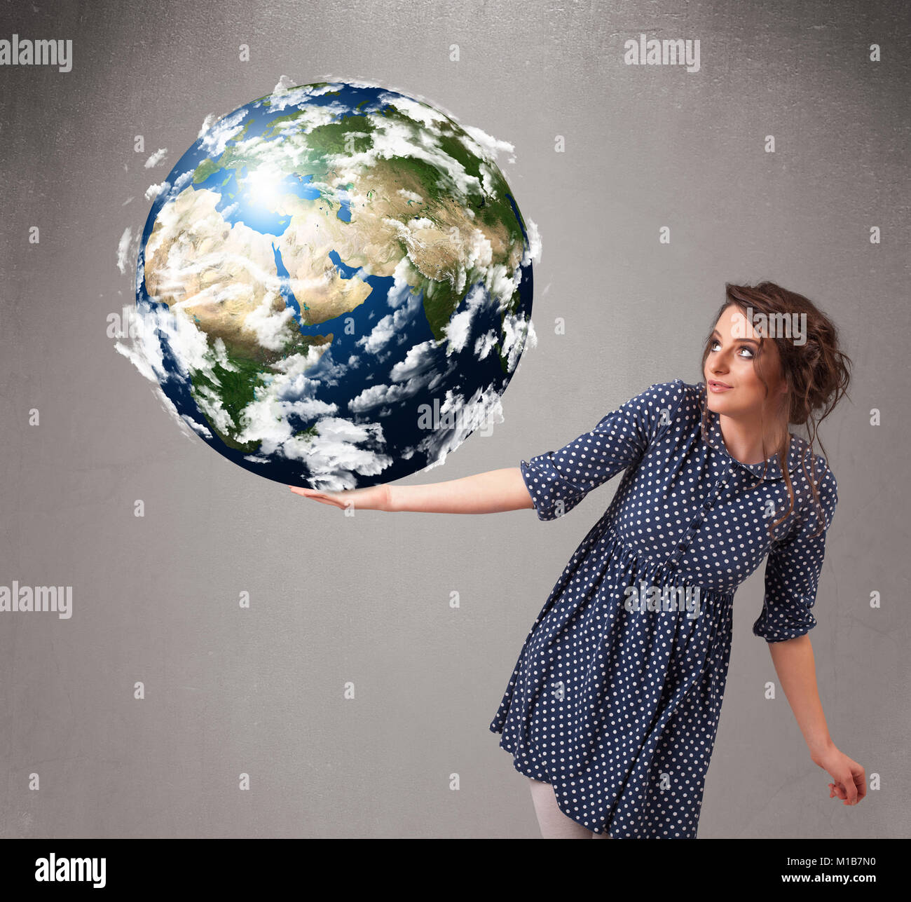 Pretty young girl holding 3d planet earth Stock Photo - Alamy