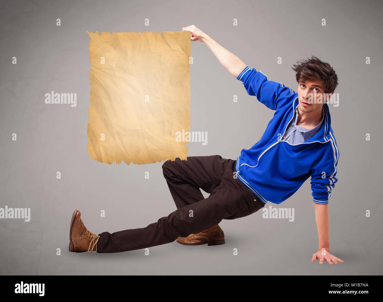 Handsome young man presenting old paper copy space Stock Photo - Alamy