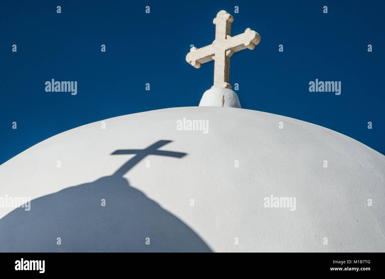Cross and shadow on church in Greece Stock Photo - Alamy