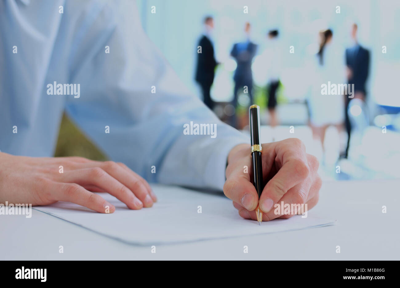 Hands writing on a paper Stock Photo - Alamy