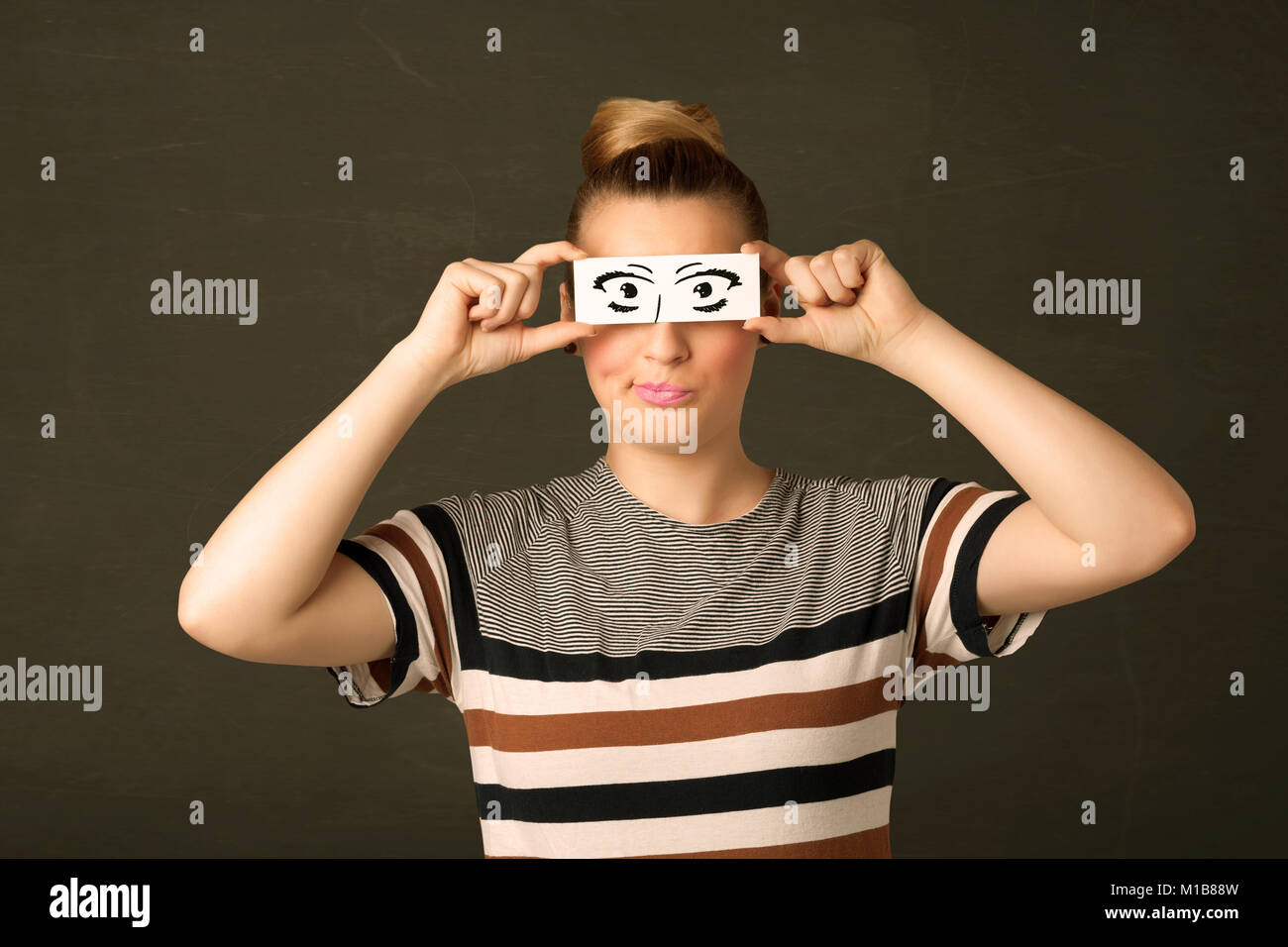 Woman looking through paper spy hi-res stock photography and images - Alamy