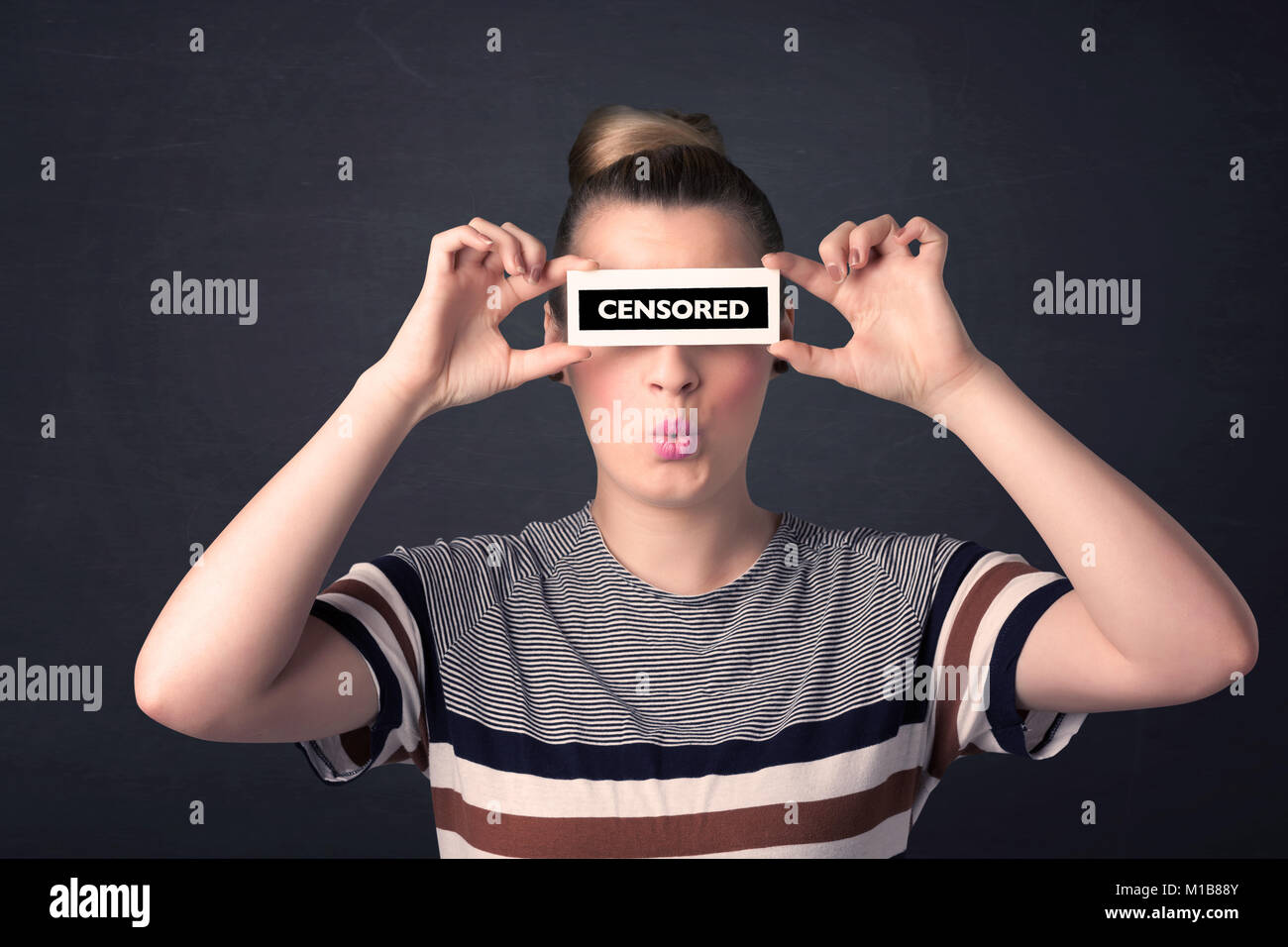 Pretty girl with censored paper sign holding in hand Stock Photo - Alamy