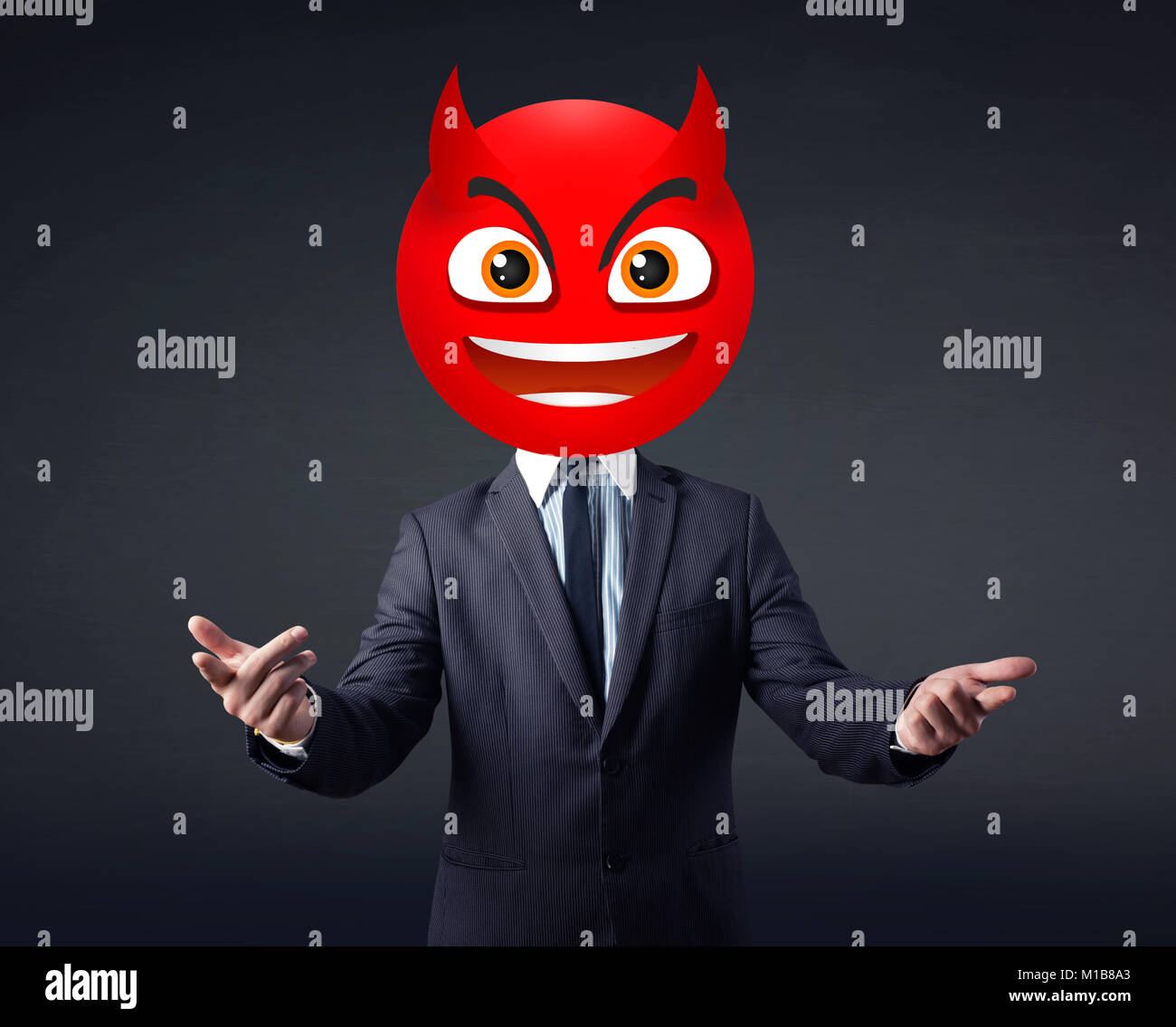 Funny businessman wears devil smiley face Stock Photo - Alamy