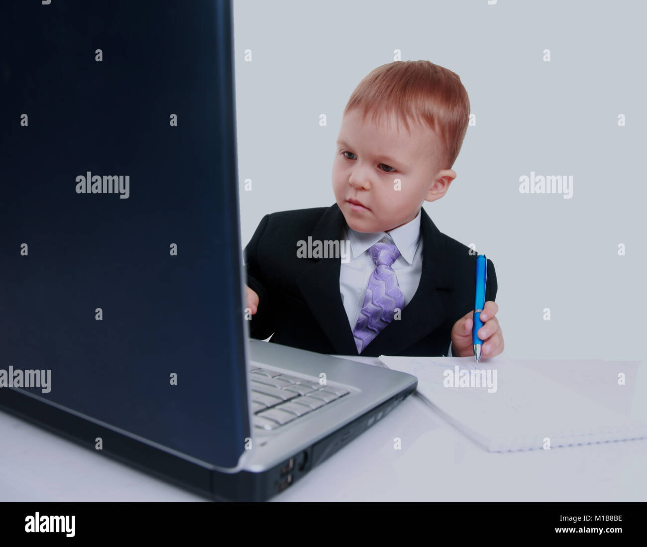 Happy boy using laptop computer Stock Photo - Alamy