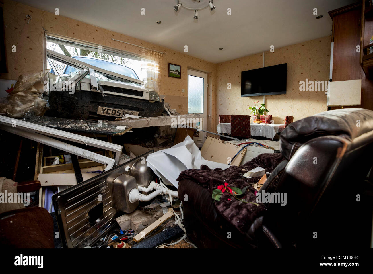 The scene where a van has crashed through the kitchen window of ...