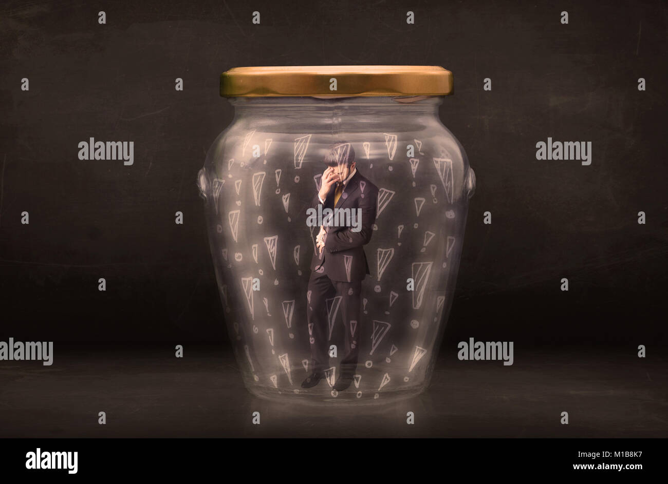 Business man trapped in jar with exclamation marks concept on ...