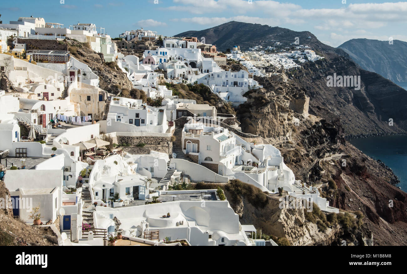 Whitewashed buildings on the rim of the crater of the Greek island of ...