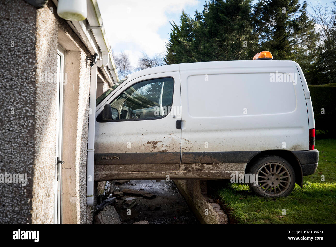 The scene where a van has crashed through the kitchen window of ...