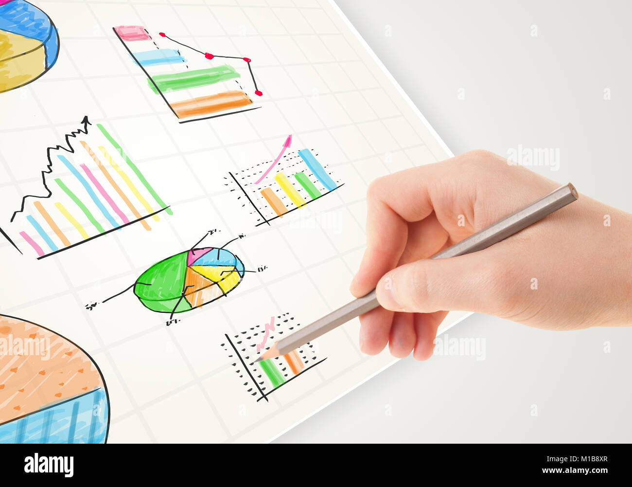 Business person drawing colorful graphs and icons on plain paper Stock ...