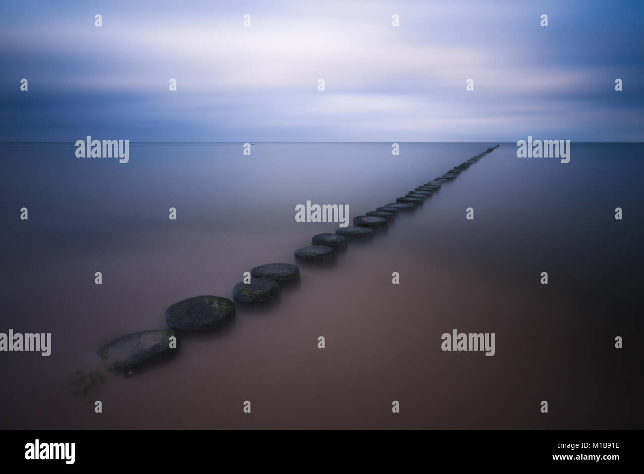 Groynes for coastal protection by the sea, taken with a long exposure ...