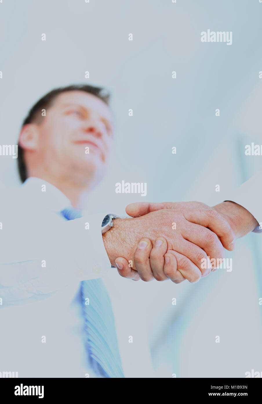 Low angle shot shake hands hi-res stock photography and images - Alamy