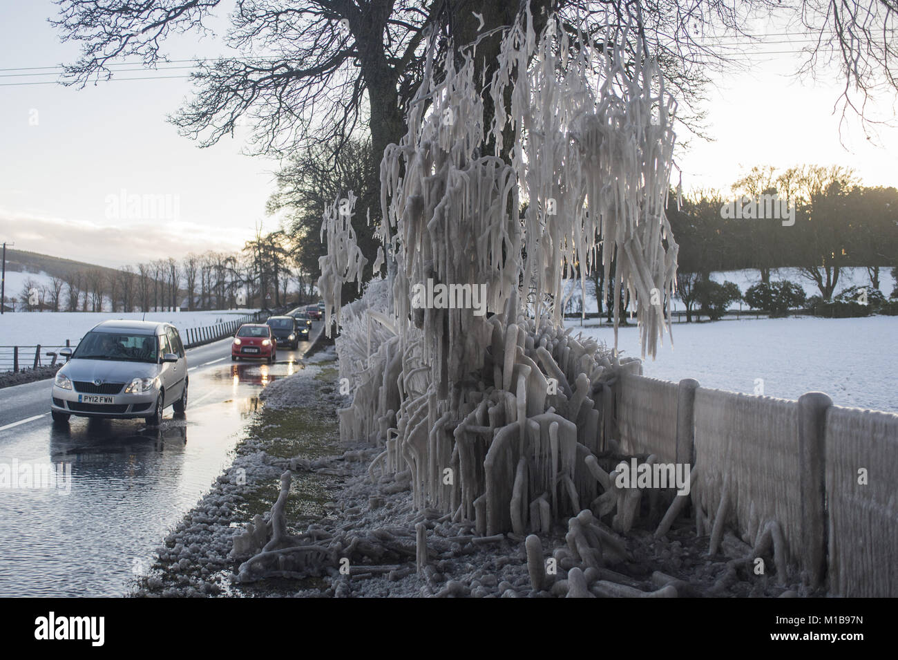 Cars driving through a puddle and sub zero temperatures create a ...