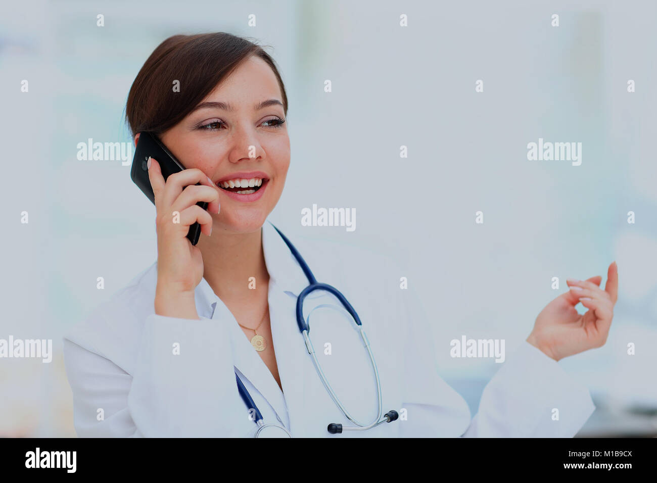 Doctor talking on telephone Stock Photo - Alamy