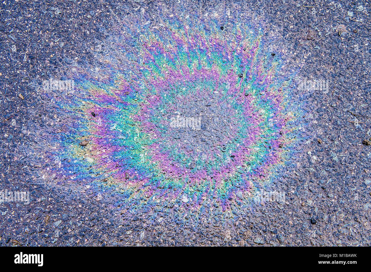 petrol stain on asphalt Stock Photo - Alamy