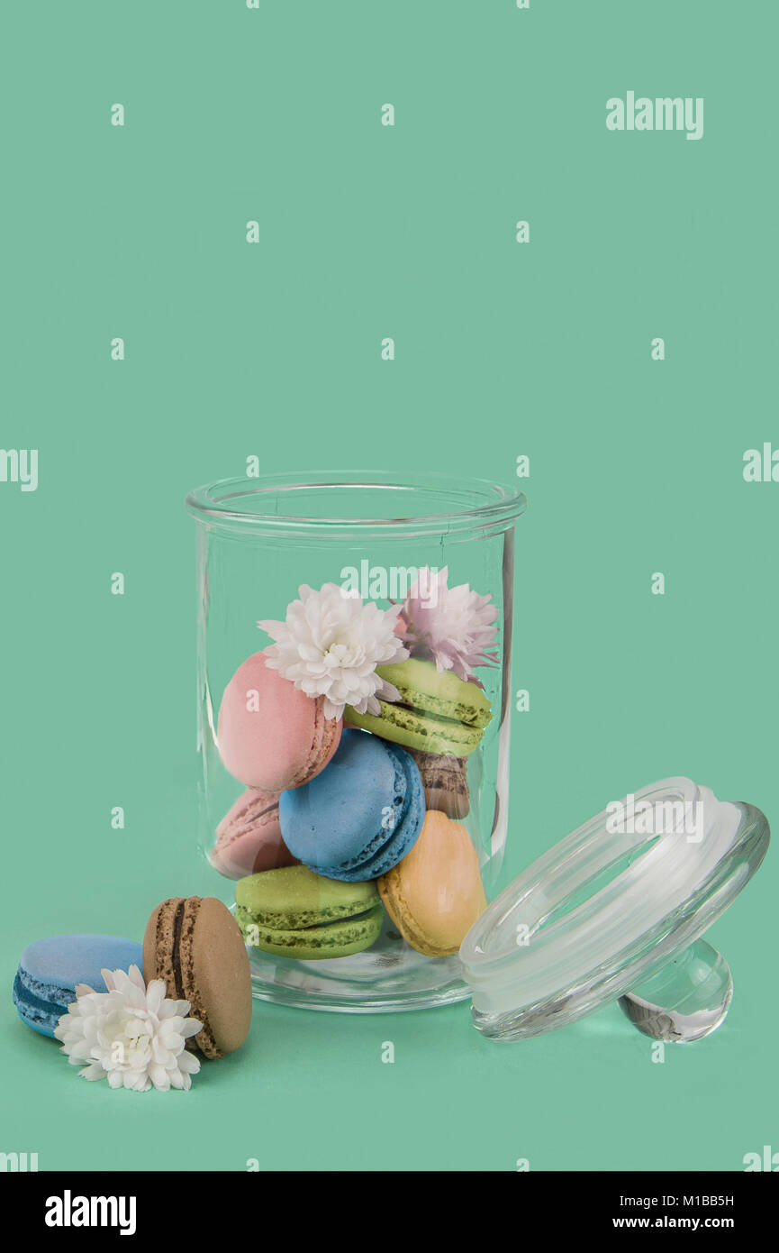 Fresh sweet colorful Macarons (Macaroons) in a glassy storage vessel in ...