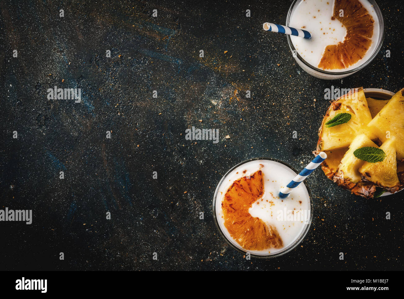 Indian food and drink, Caramelized Pineapple Lassi cocktail, dark blue ...