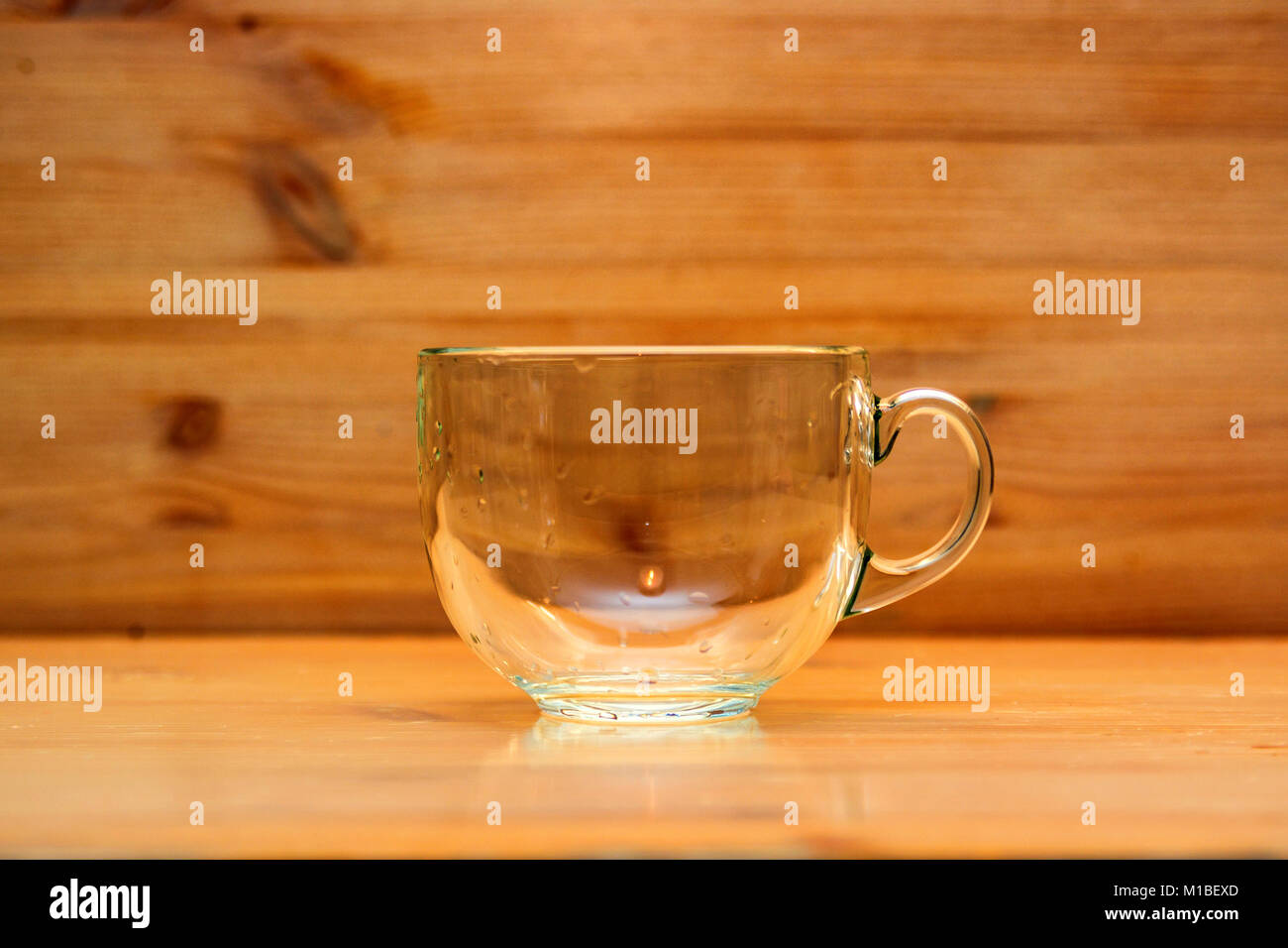 Close up transparent empty teacup on wooden background Stock Photo - Alamy
