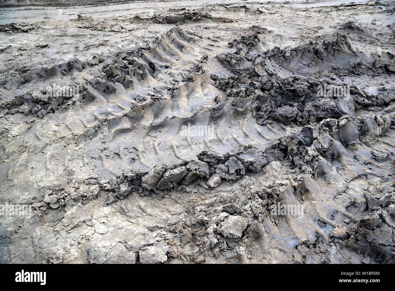Background made of tyre tracks left in muddy ground Stock Photo - Alamy