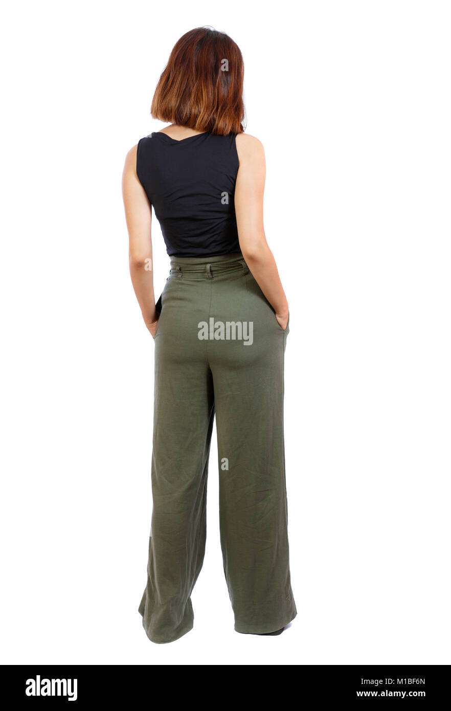 back view of standing young beautiful woman. girl watching. Rear view ...