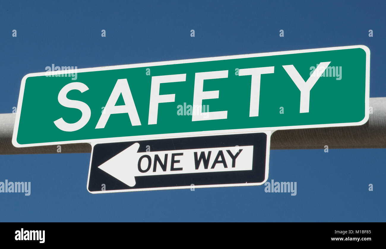 Safety One Way green highway sign Stock Photo - Alamy