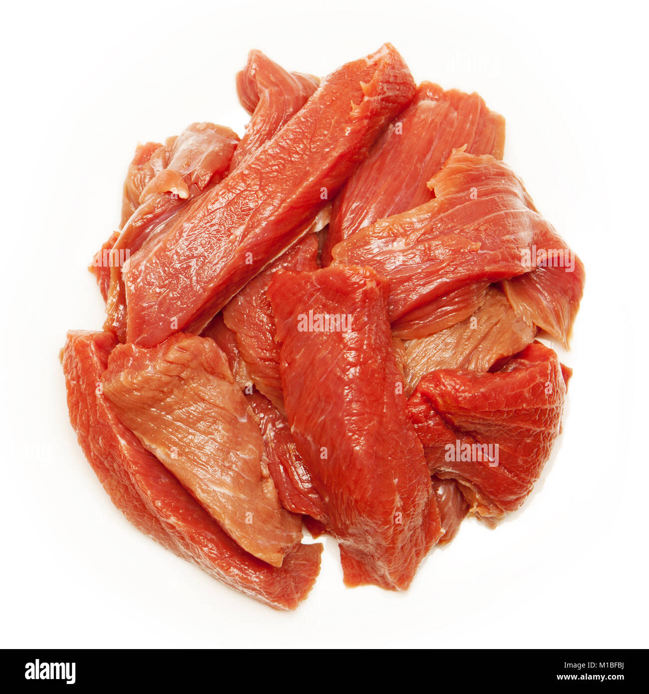 Meat of veal which is sliced in pieces on a white background Stock ...