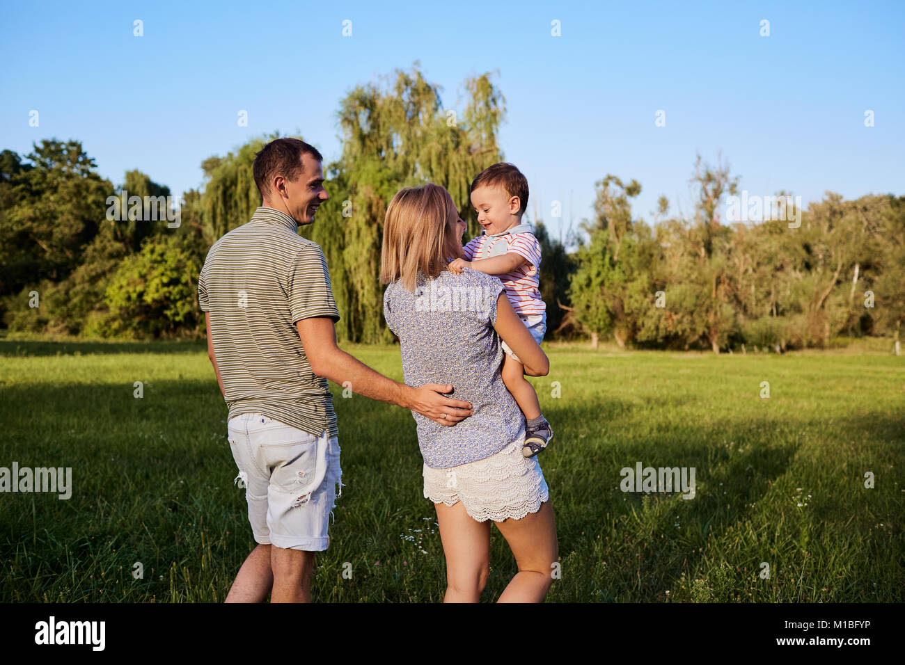 Happy family in nature Stock Photo - Alamy