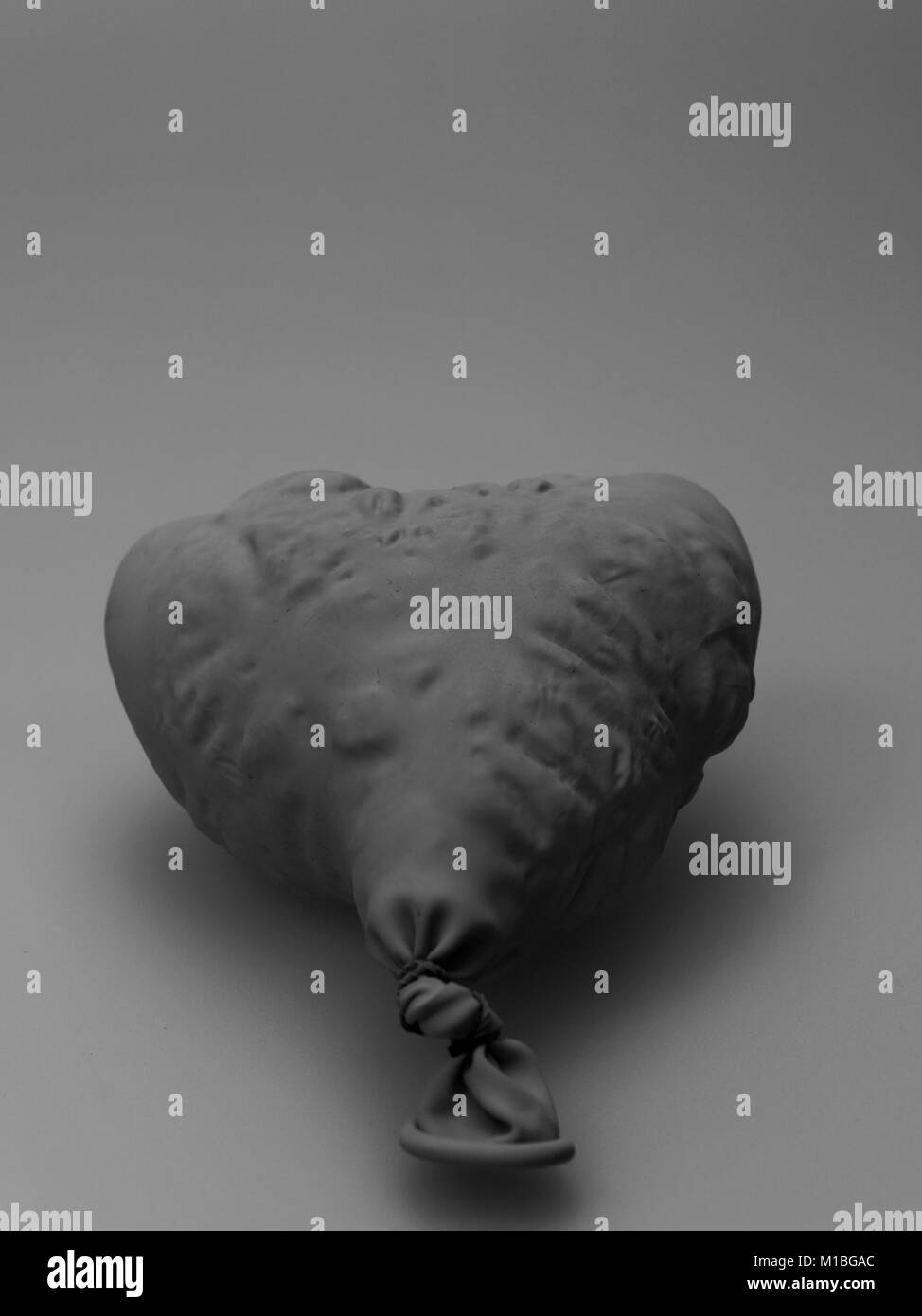 Deflate heart shape balloon in black and white isolated on white ...