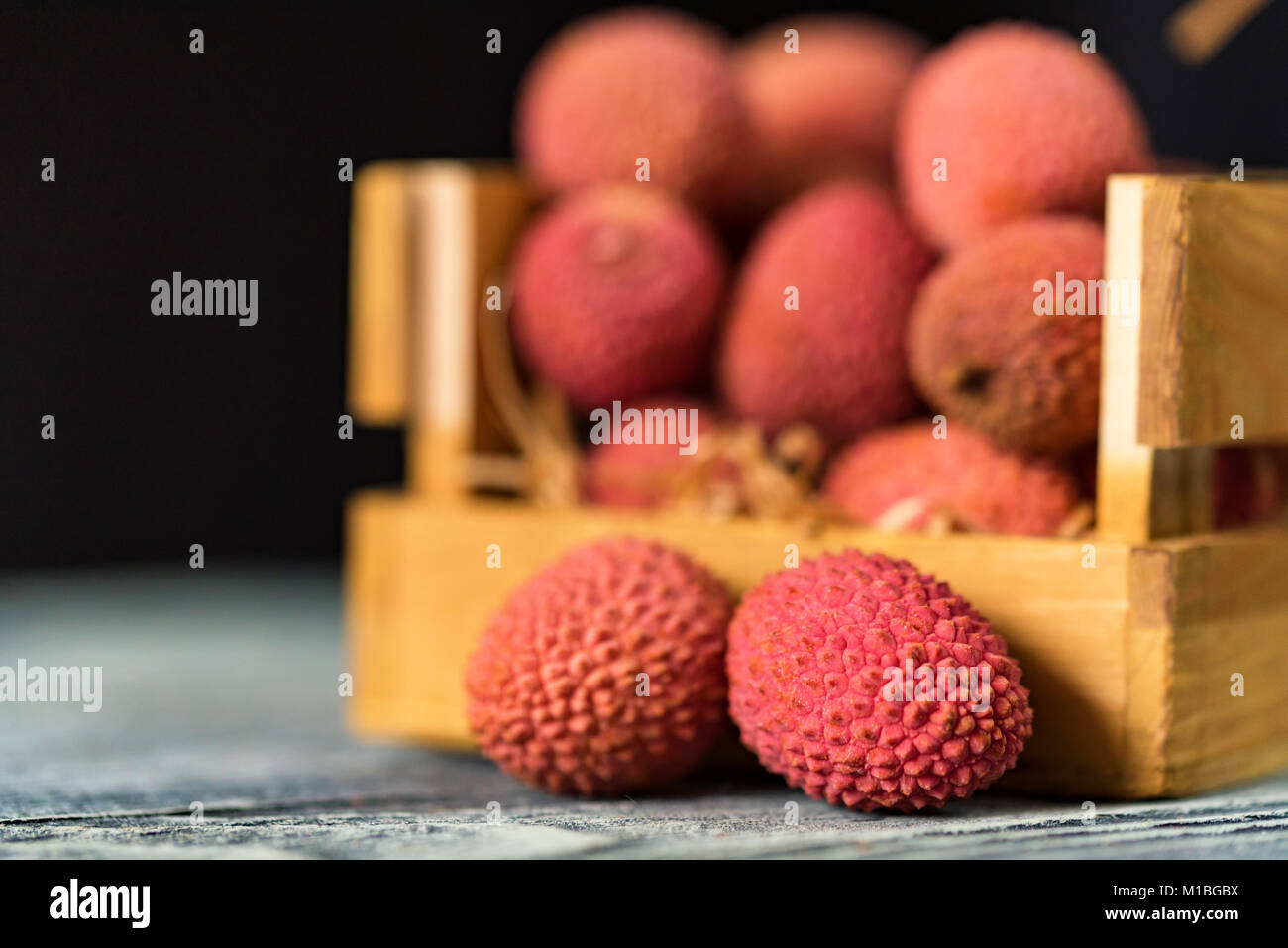 Lychee fruit in wooden box close Stock Photo - Alamy