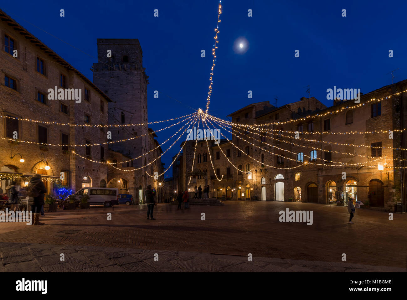 The moon above Piazza della Cisterna in San Gimignano, Siena, Tuscany ...