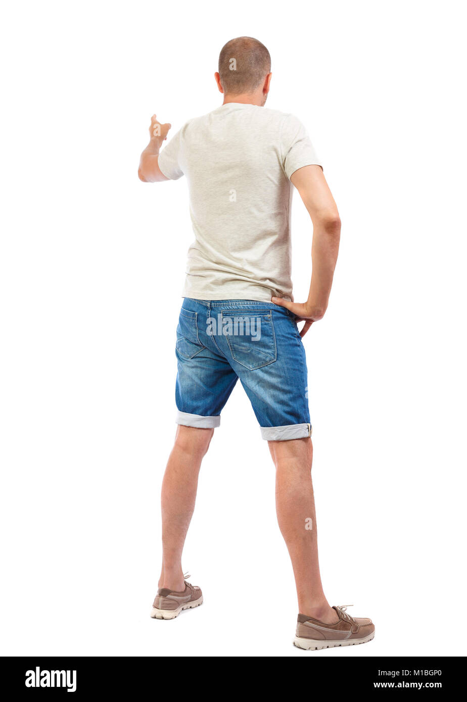 Back view of pointing young men in shirt and jeans. Young guy gesture ...
