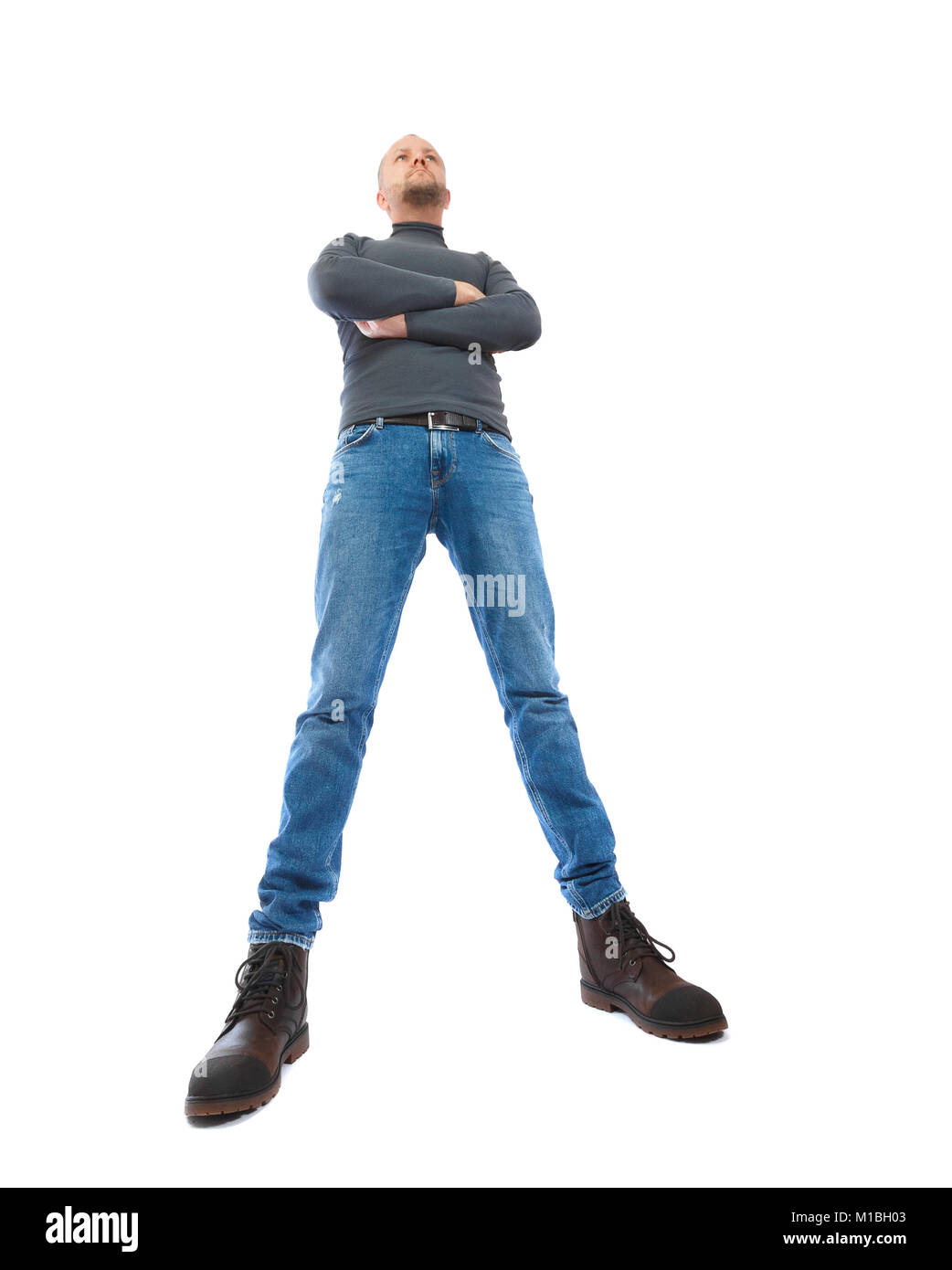 A bottom view of a wide angle on a serious man with a folded hand on ...