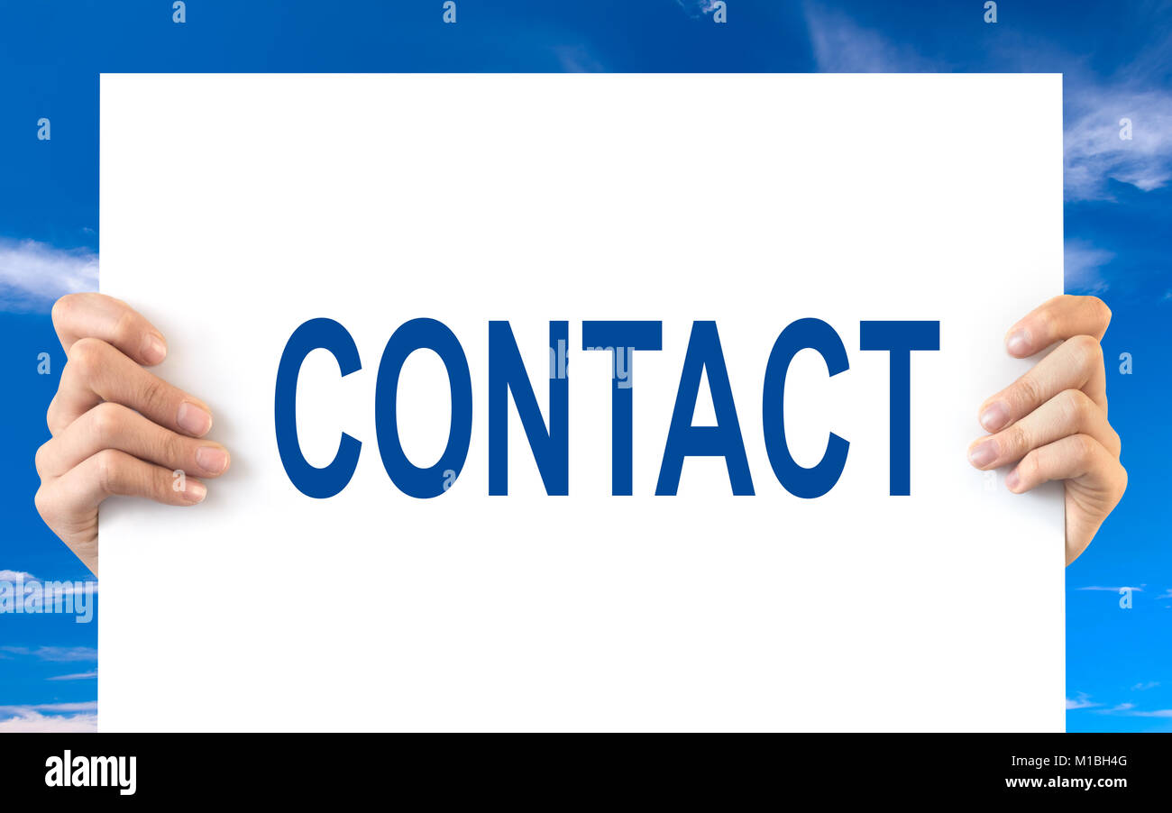 Hands holding a white board with the word contact, blue sky background ...