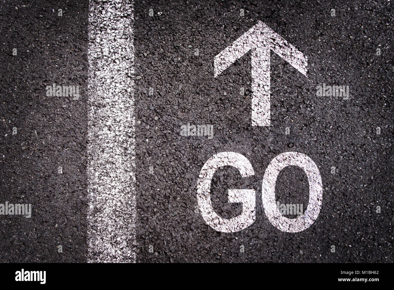Word go and an arrow written on an asphalt road background Stock Photo ...