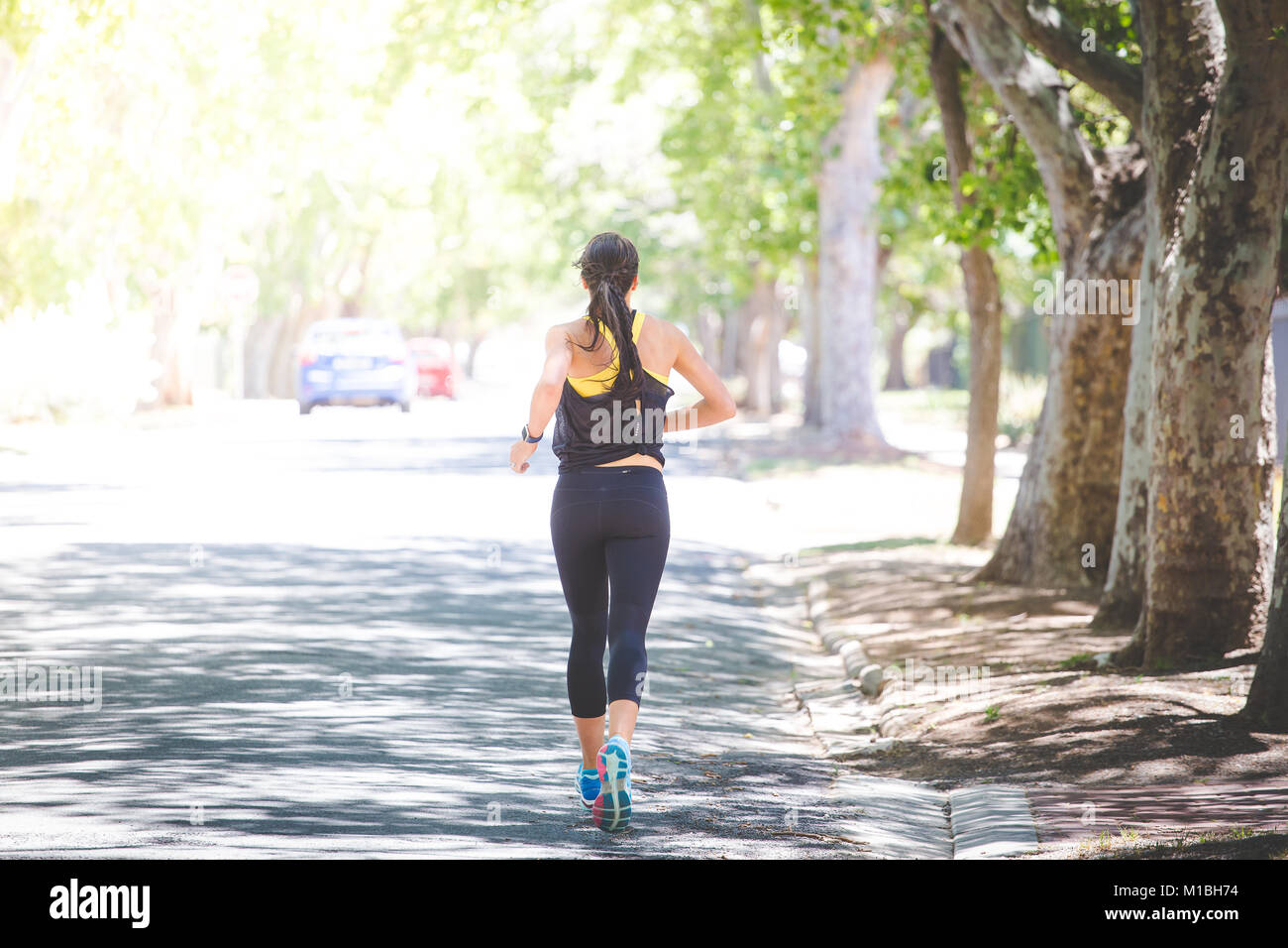 Beautiful brunette female fitness model running / stretching ...