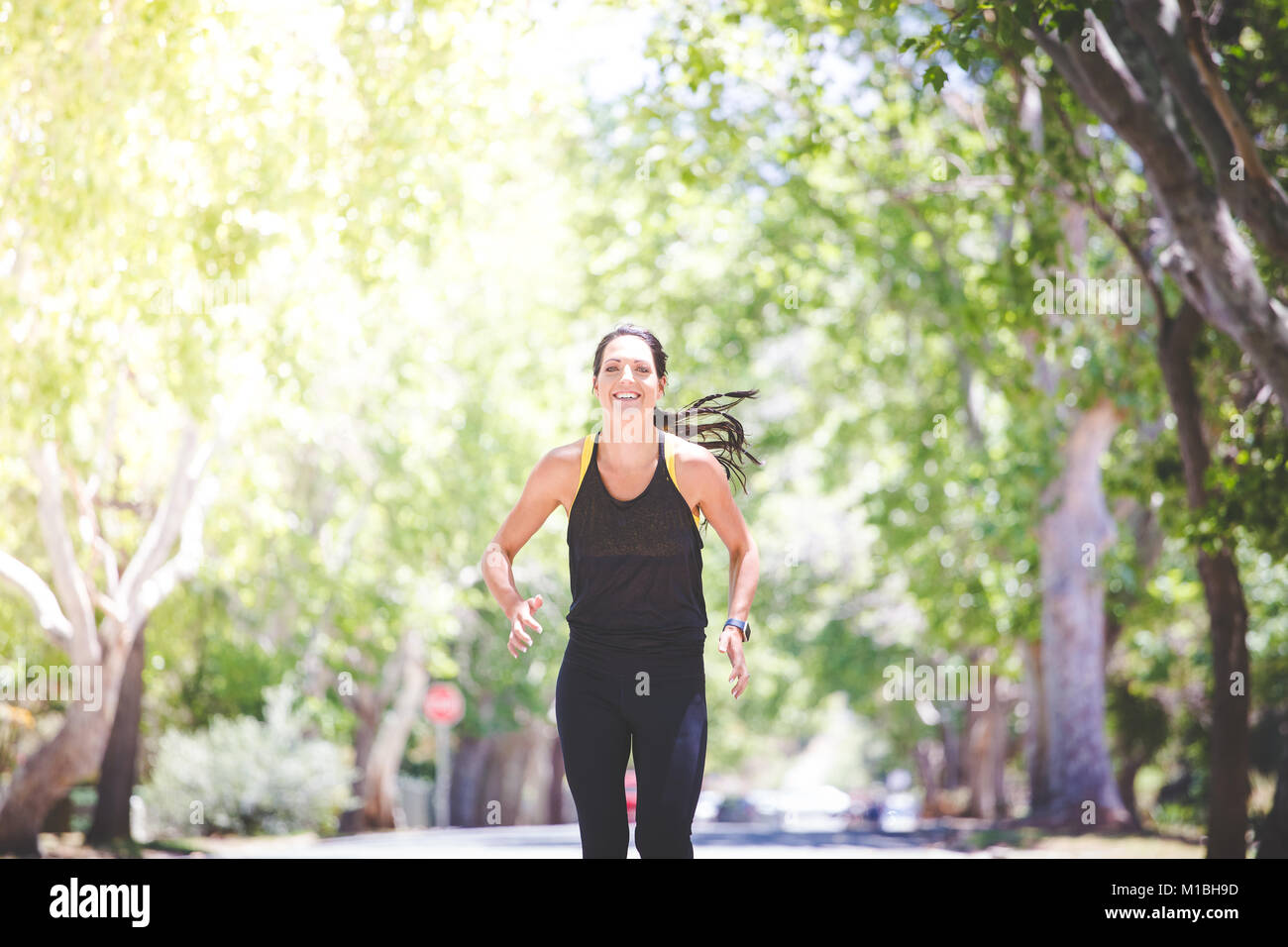 Beautiful brunette female fitness model running / stretching ...