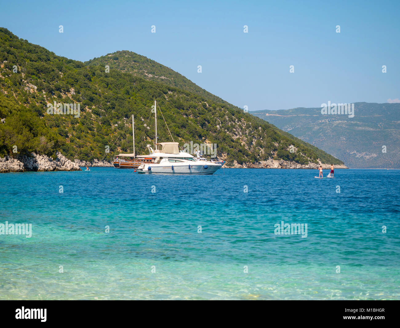 Boats in a shore and people enjoy the summer in Kefalonia island ...