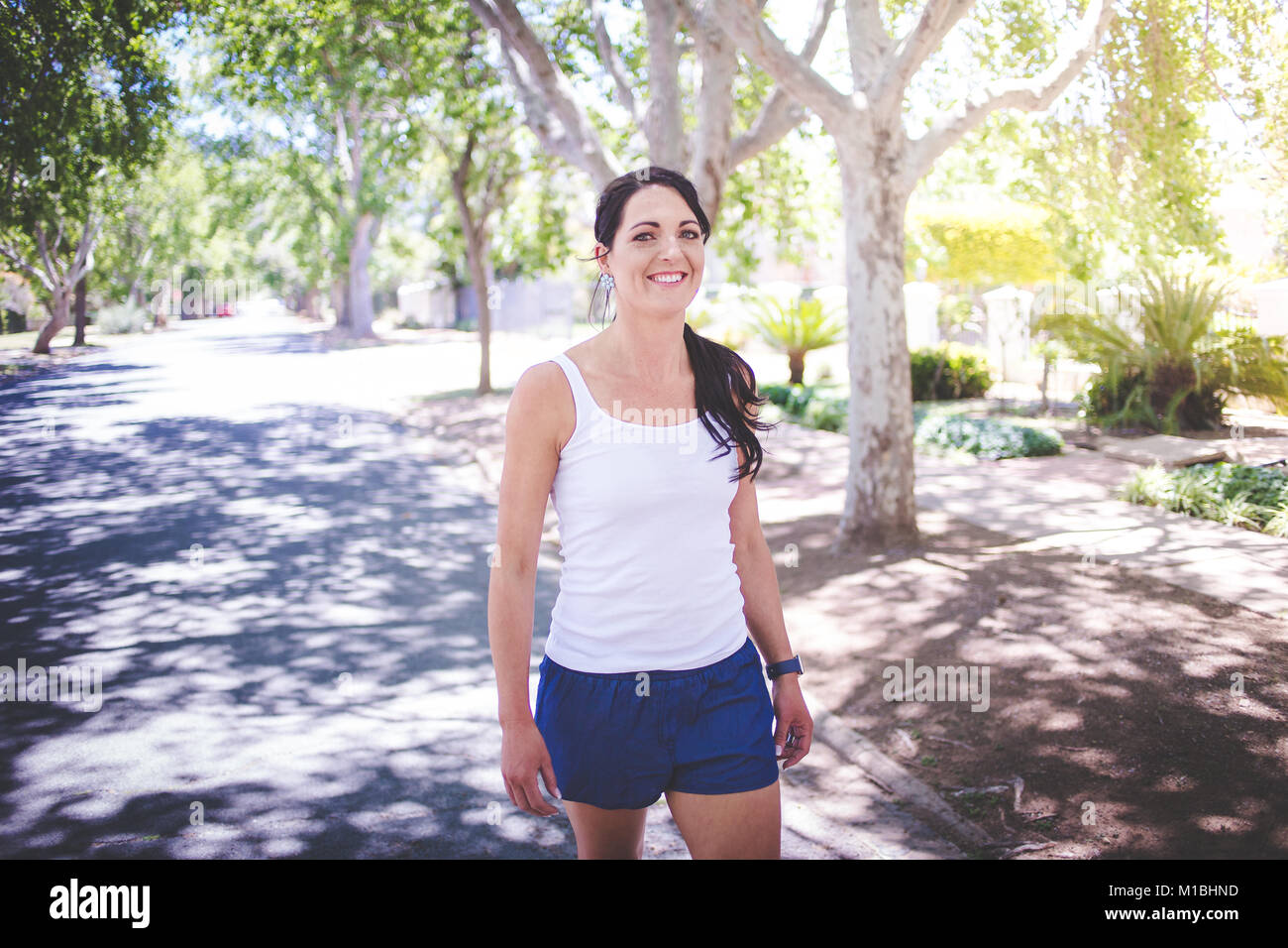 Beautiful brunette female fitness model running / stretching ...