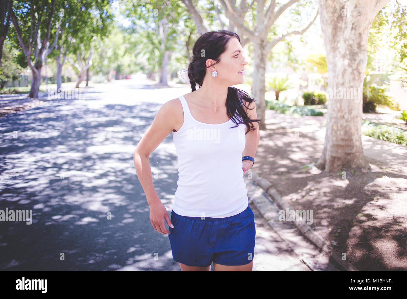 Beautiful brunette female fitness model running / stretching ...
