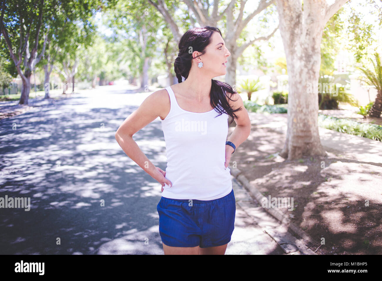 Beautiful brunette female fitness model running / stretching ...